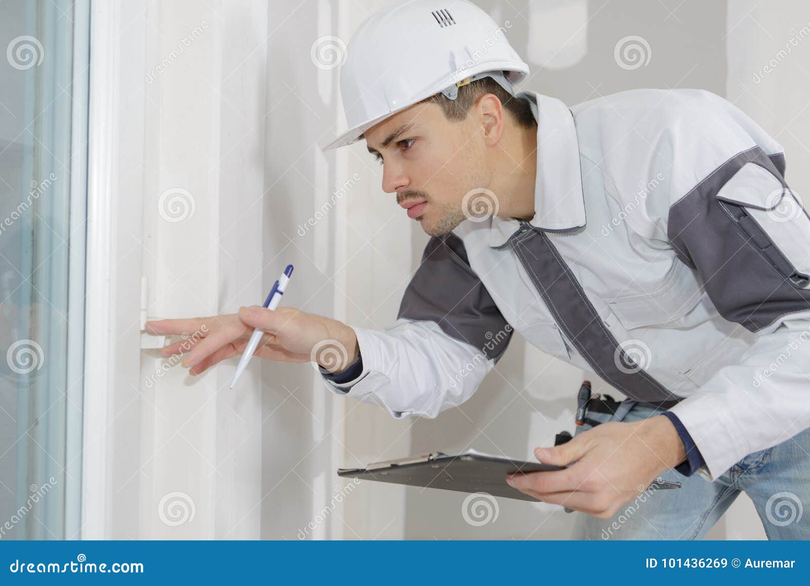 Young Builderchecking Wall in Construction Site Stock Image - Image of ...