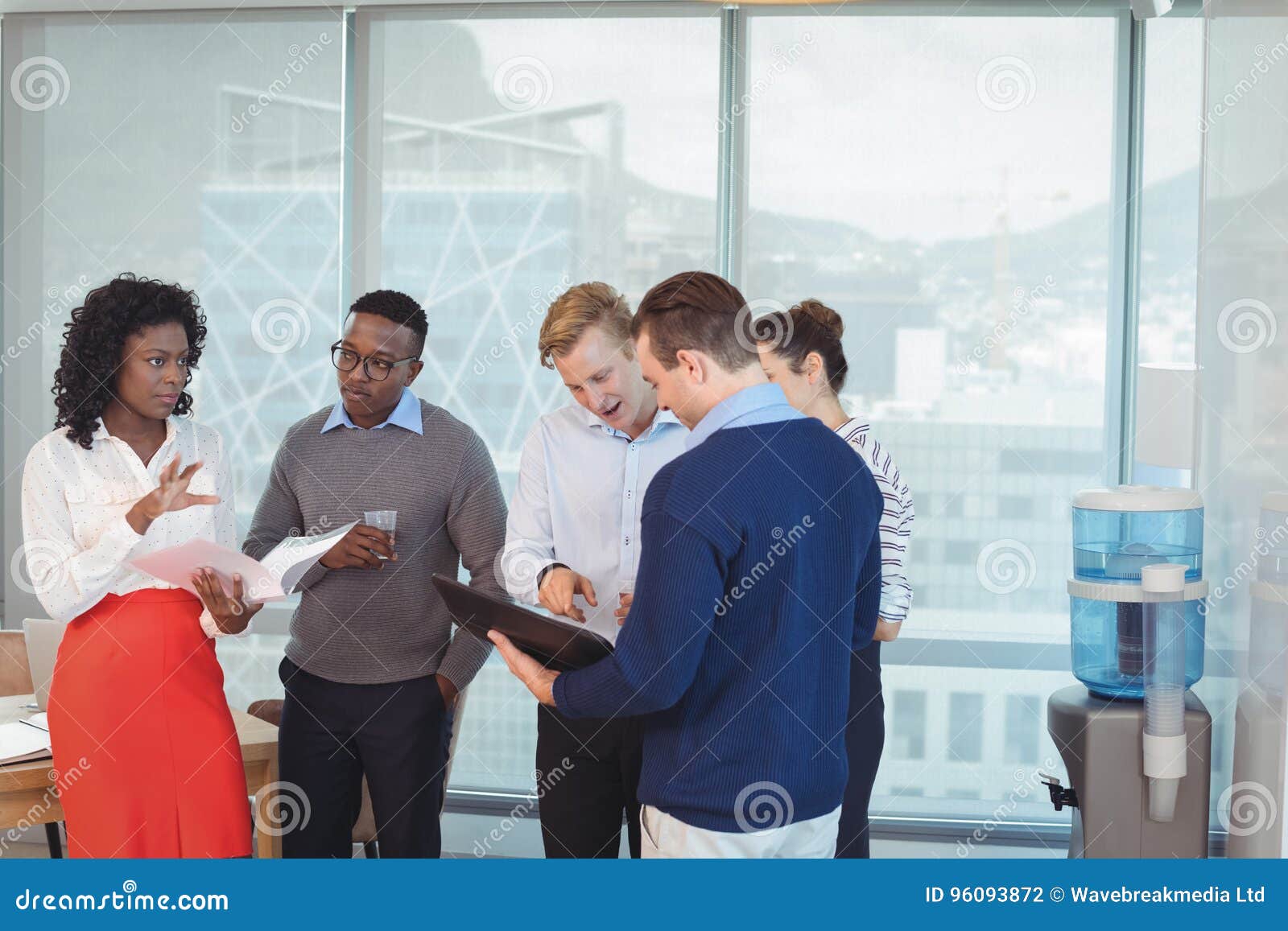 Young Business Colleagues Discussing in Office Stock Photo - Image of ...