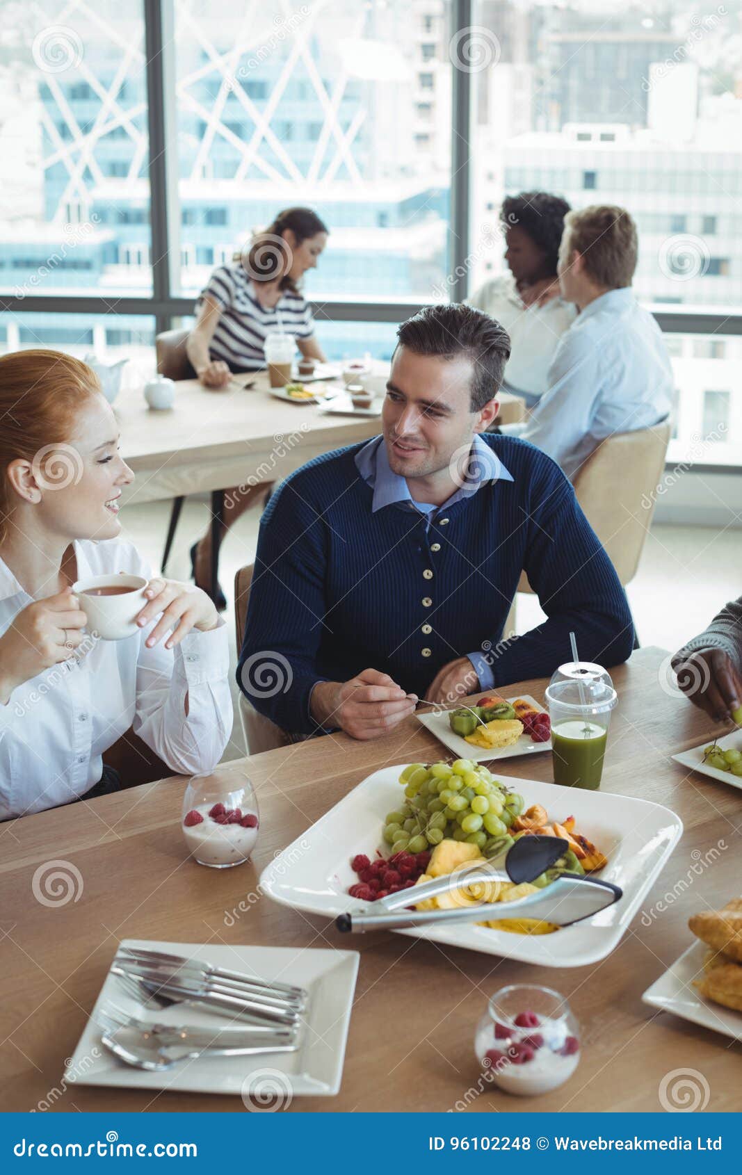 Young Business Colleagues Talking at Breakfast Table Stock Photo ...
