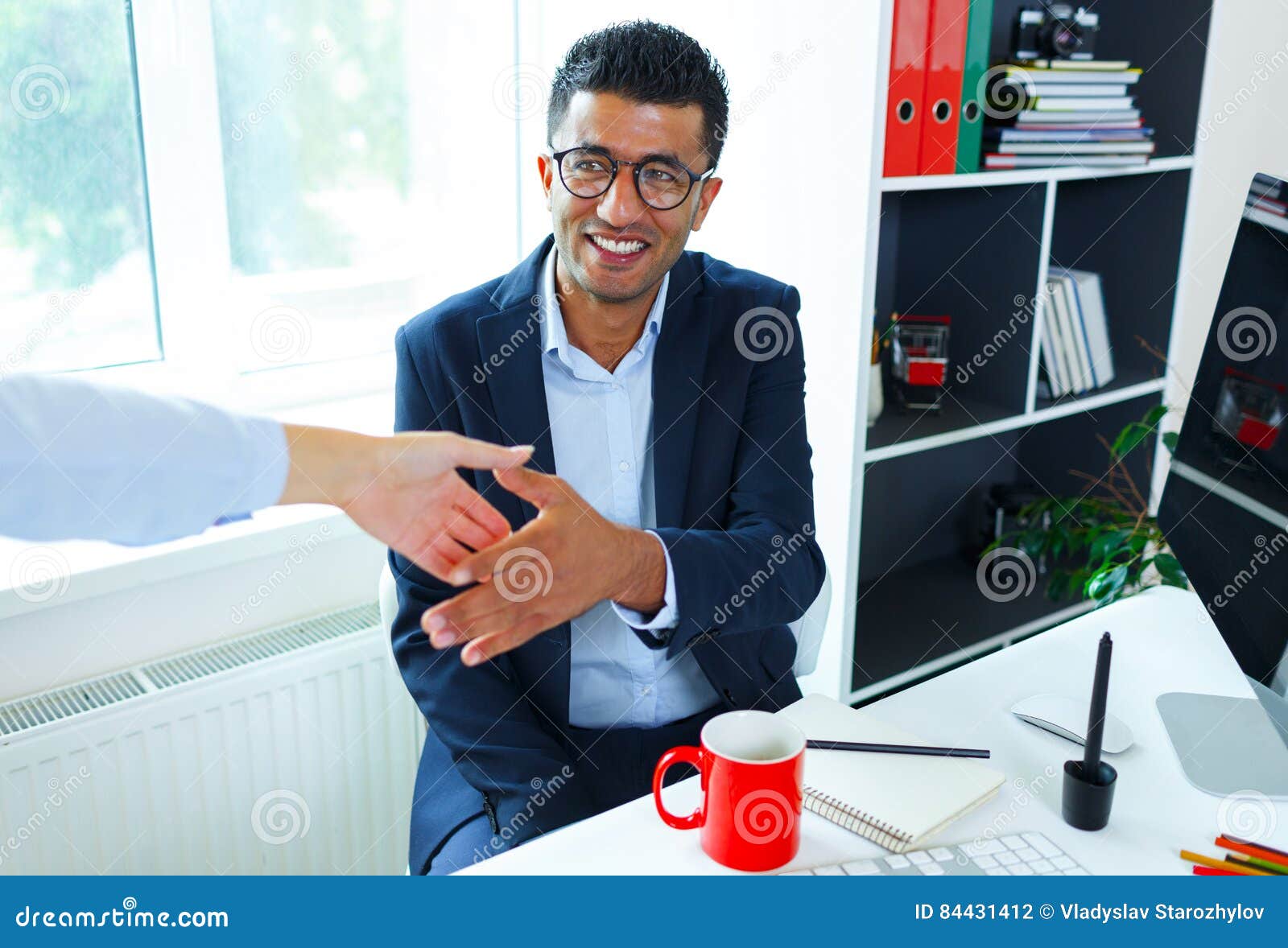 Young Business Man with Arm Extended To Handshake Stock Photo - Image ...