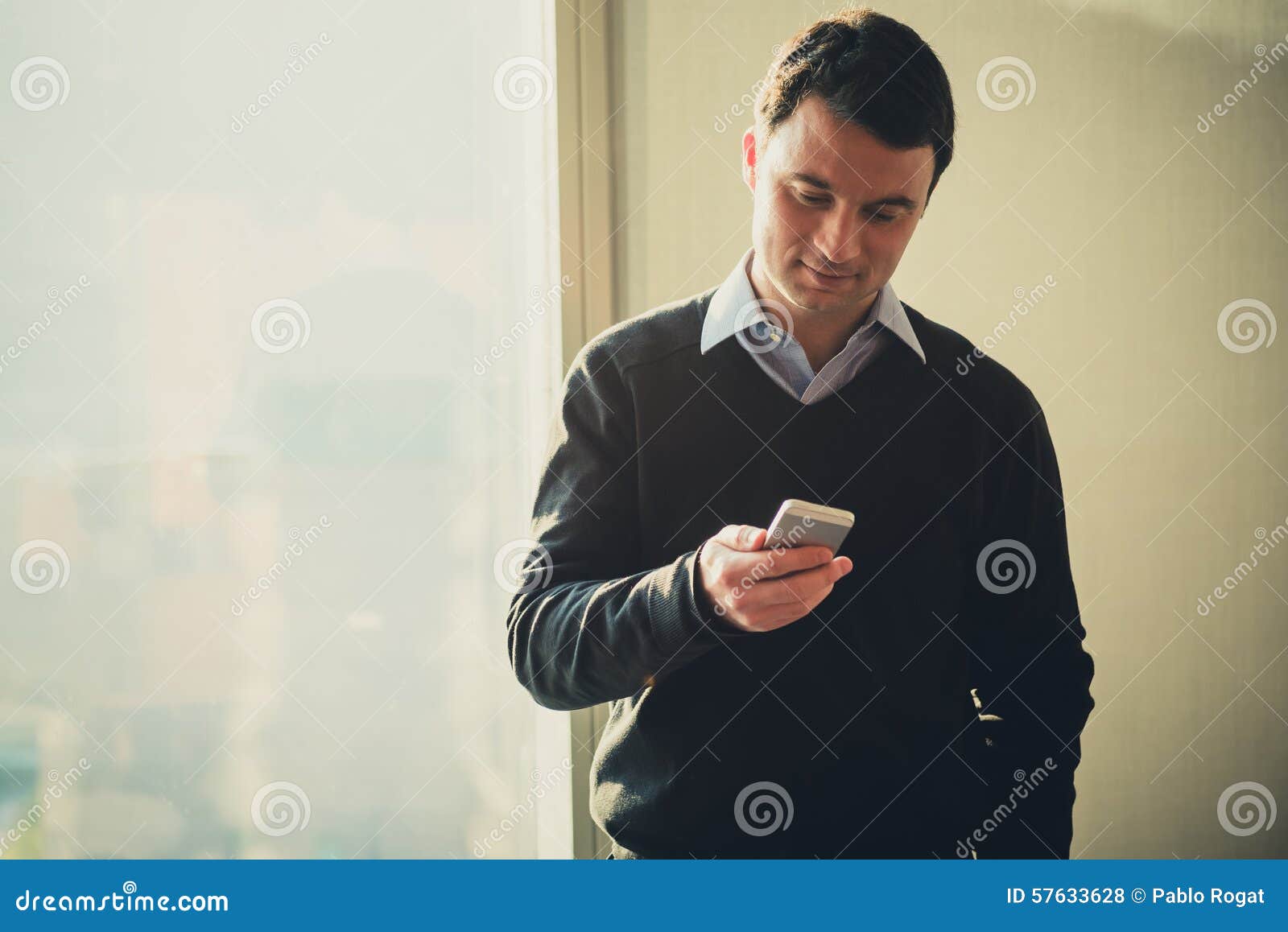 Young Business Man at the Office in a Corporate Building Using His Cell ...