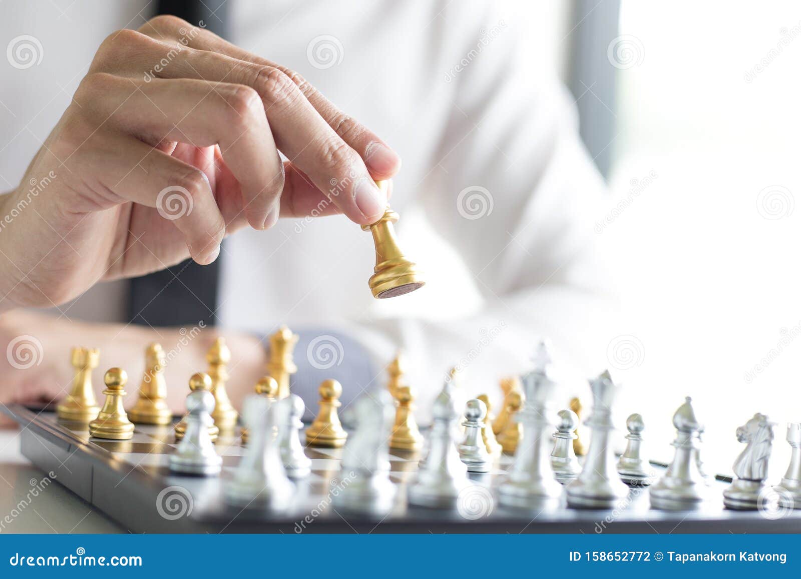 A Young Business Man is Playing Chess, Business Strategy To Be ...