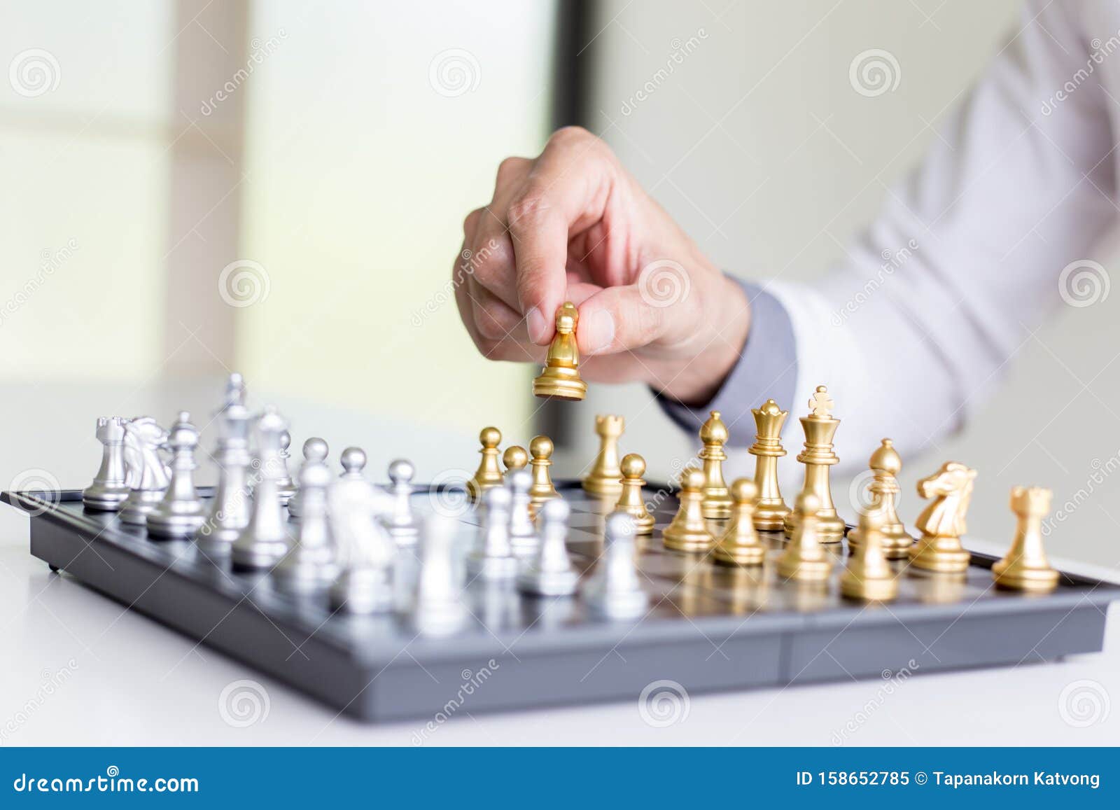 A Young Business Man is Playing Chess, Business Strategy To Be ...