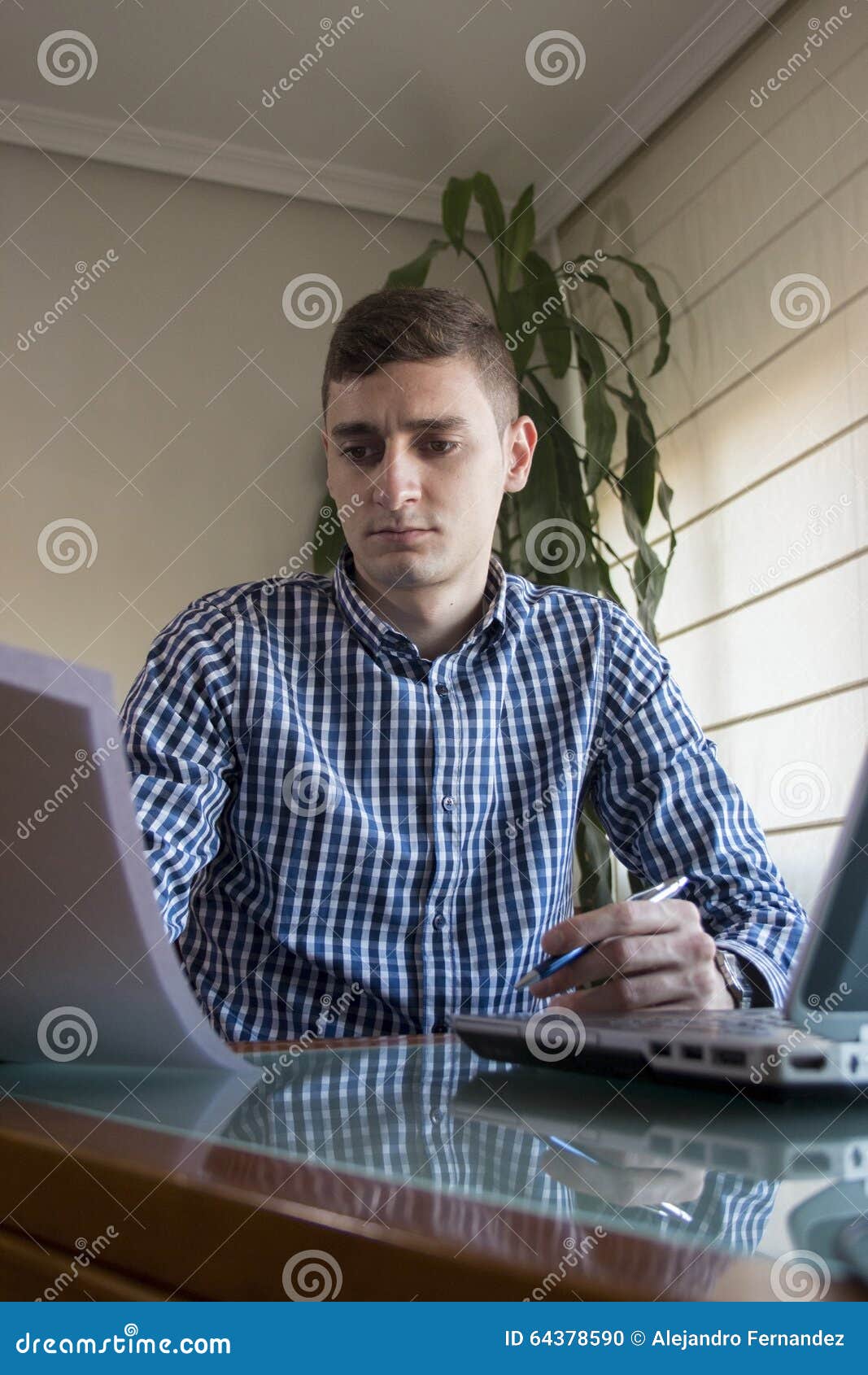Young Business Man Reading Some Papers at Home Office Stock Photo ...
