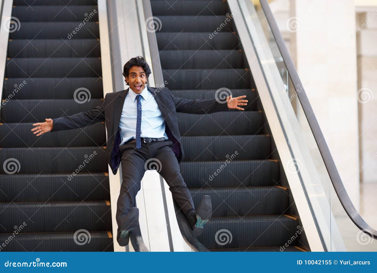 Young Business Man Sliding Down the Escalator Stock Image - Image of ...