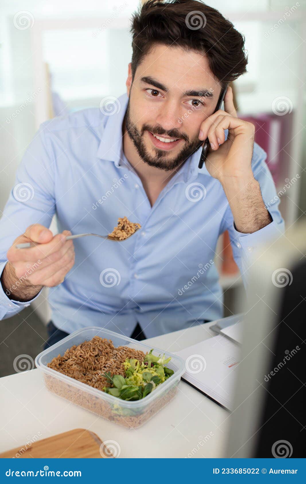Young Business Man Talking on Phone while Eating Stock Photo - Image of ...