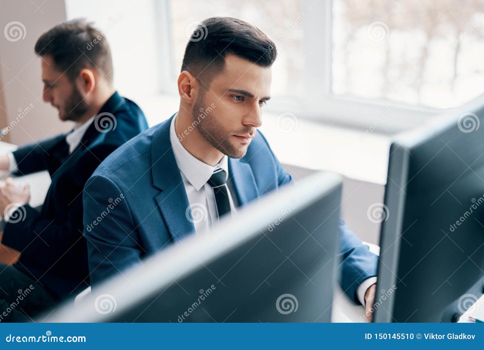Young Business Man Working on Computer in His Workplace Stock Photo ...