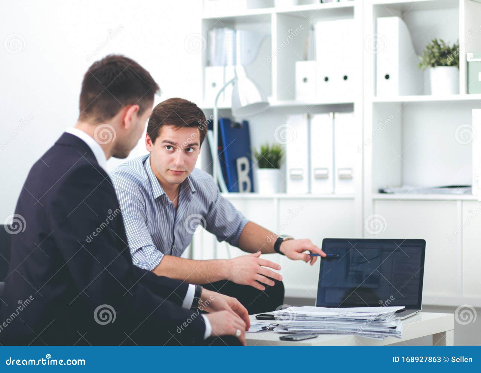 Young Business Man Sitting Against at Table in Office Stock Image ...