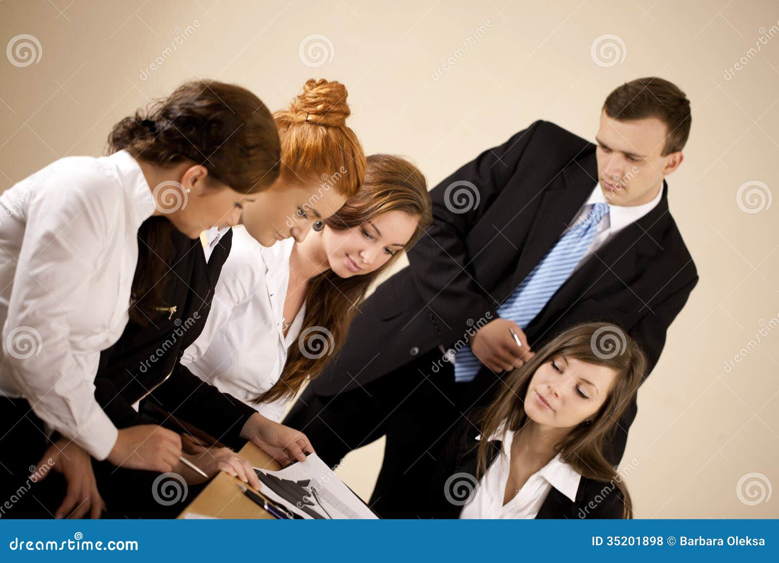 Young Business People Analyzing Chart Stock Photo - Image of looking ...