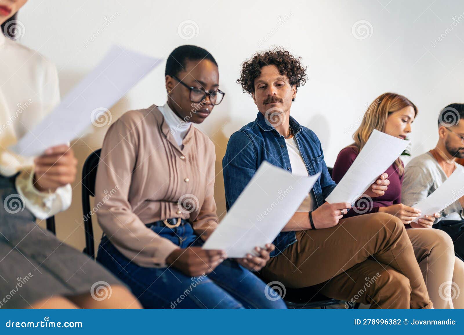 Young Business People Sitting in Chairs and Waiting for an Interview ...