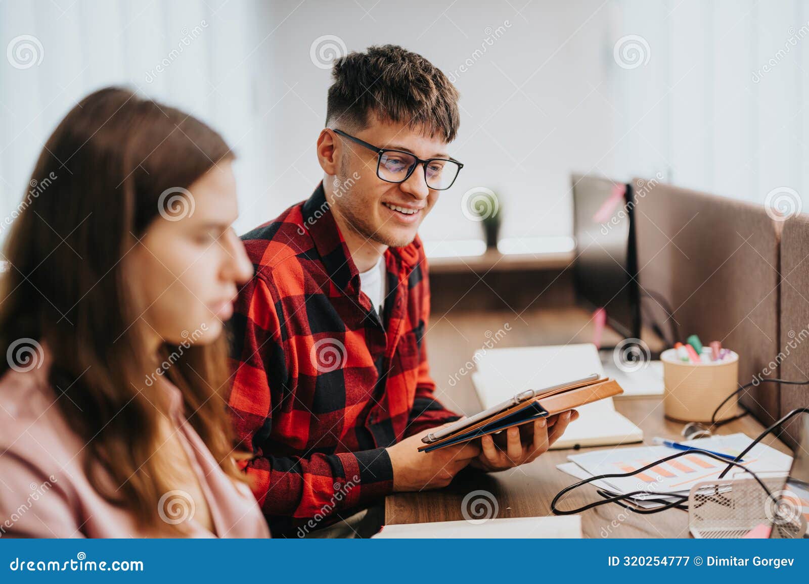 Young Business Professionals Collaborating on a Project in a Modern ...