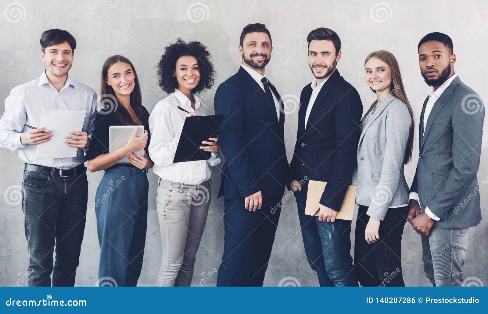 Young Business Team Looking at Camera in Office Stock Photo - Image of ...