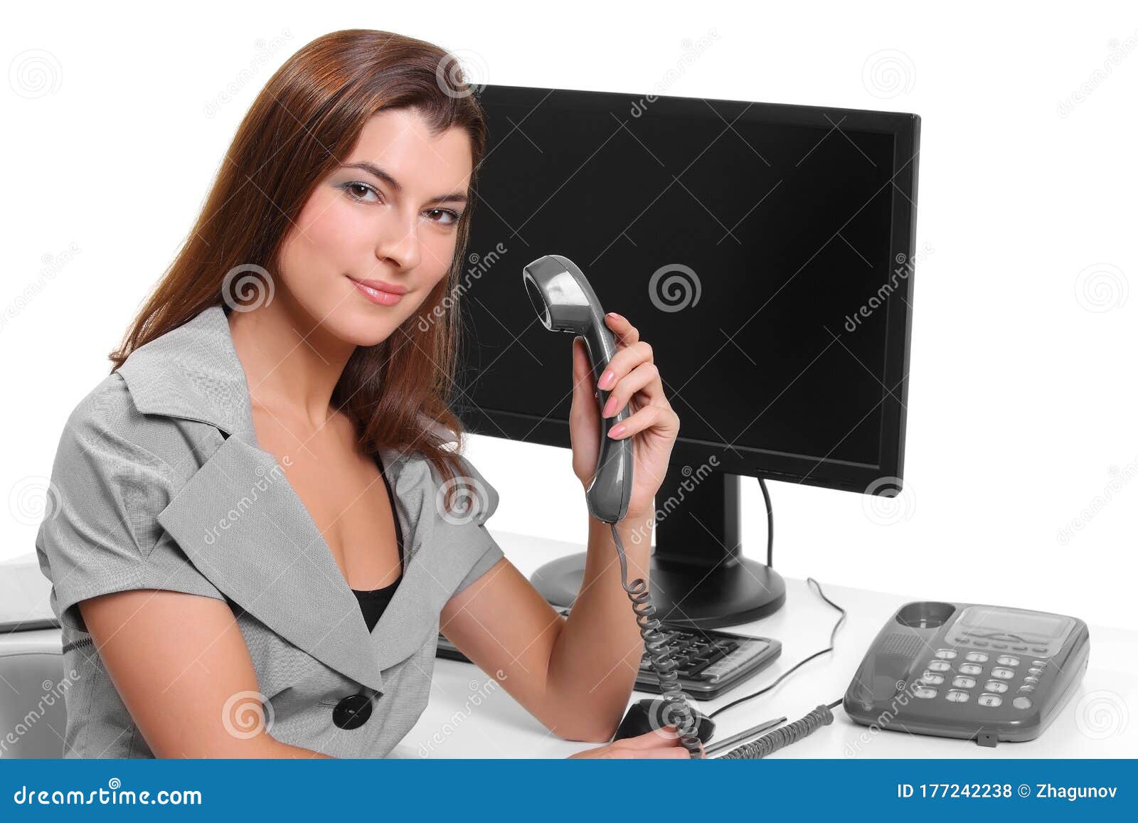 Business Woman on Phone while Using Computer at Workplace Stock Photo ...