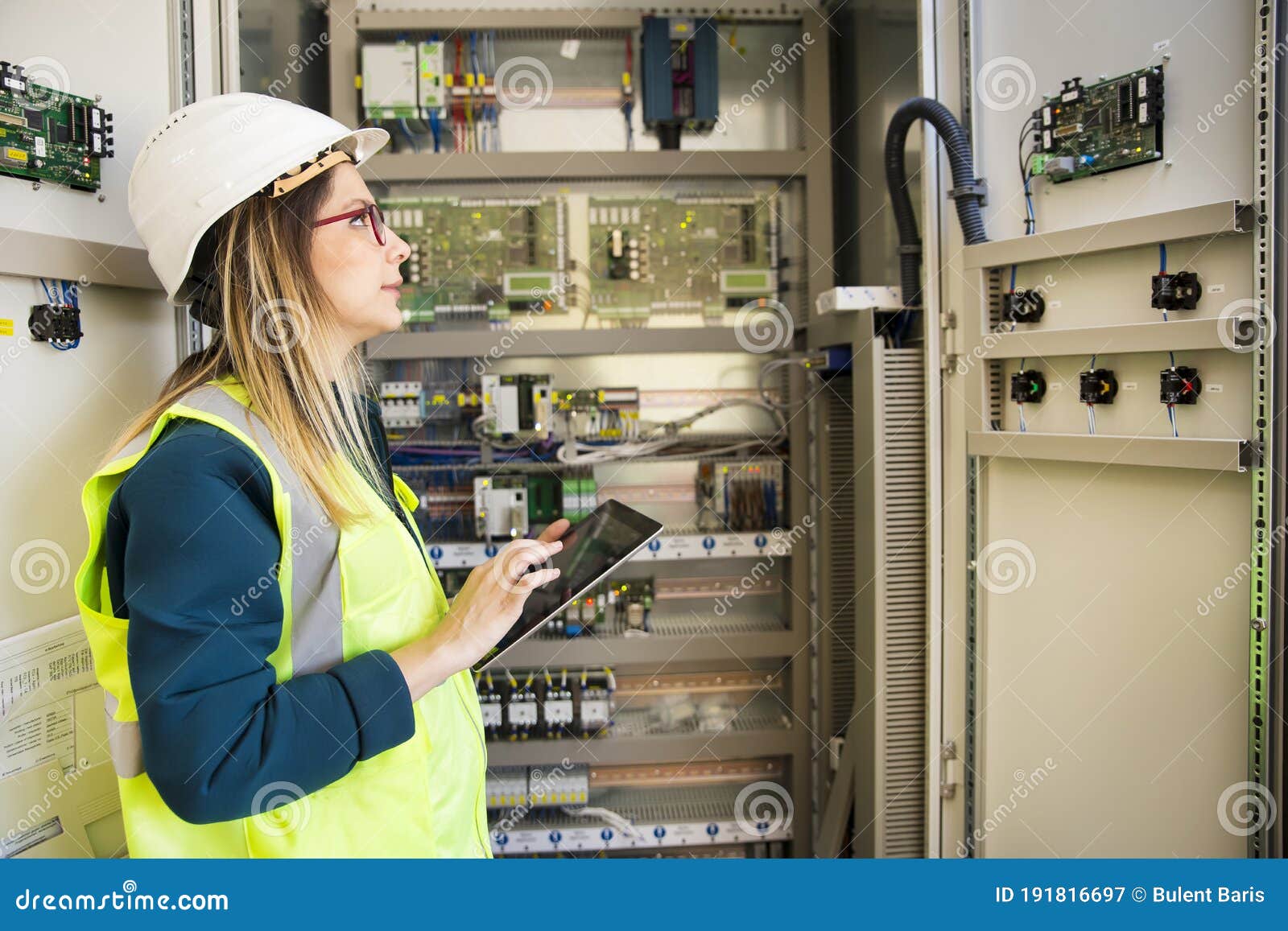 Young Business Woman Standing in Front of the Control Panel in the ...