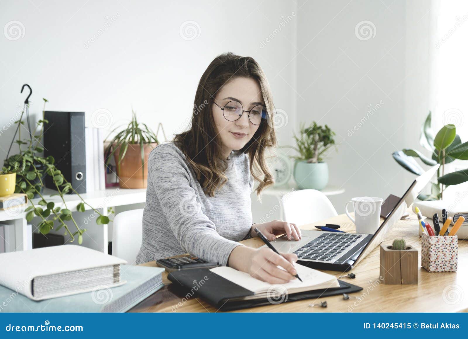 Young Business Woman Taking Notes in Notebook at Office. Stock Image ...
