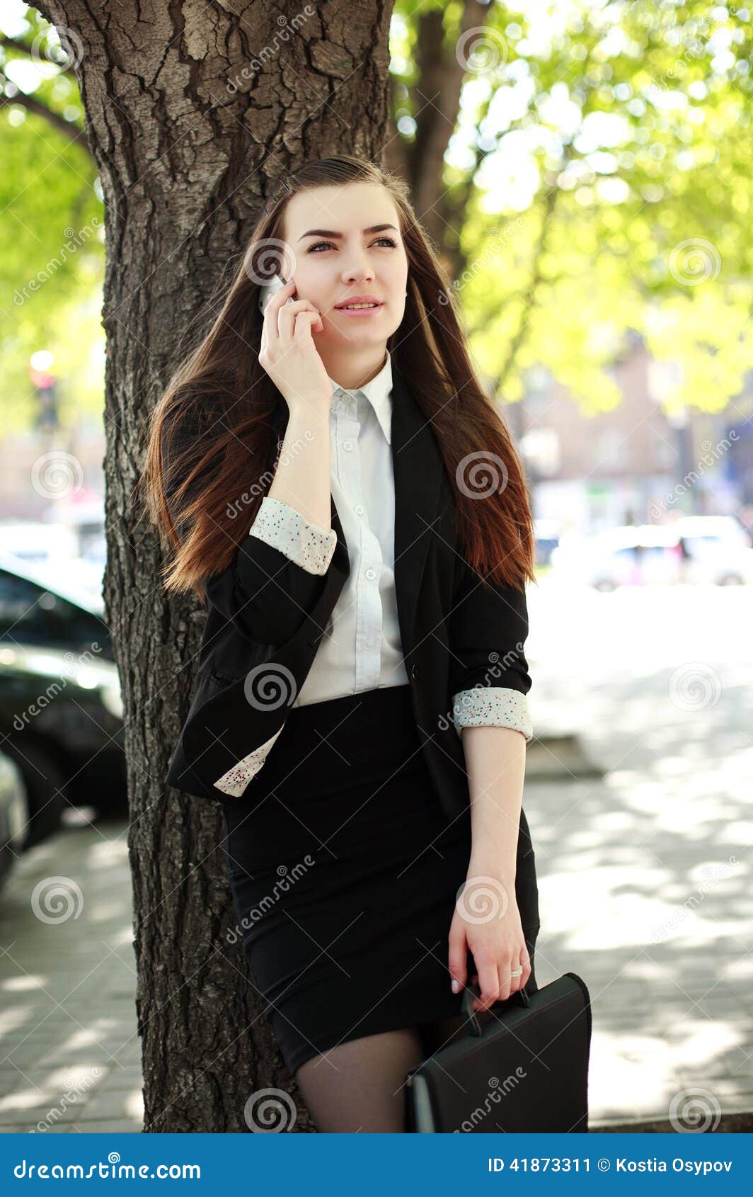 Young Business Woman Talking on the Phone Under a Tree Stock Image ...