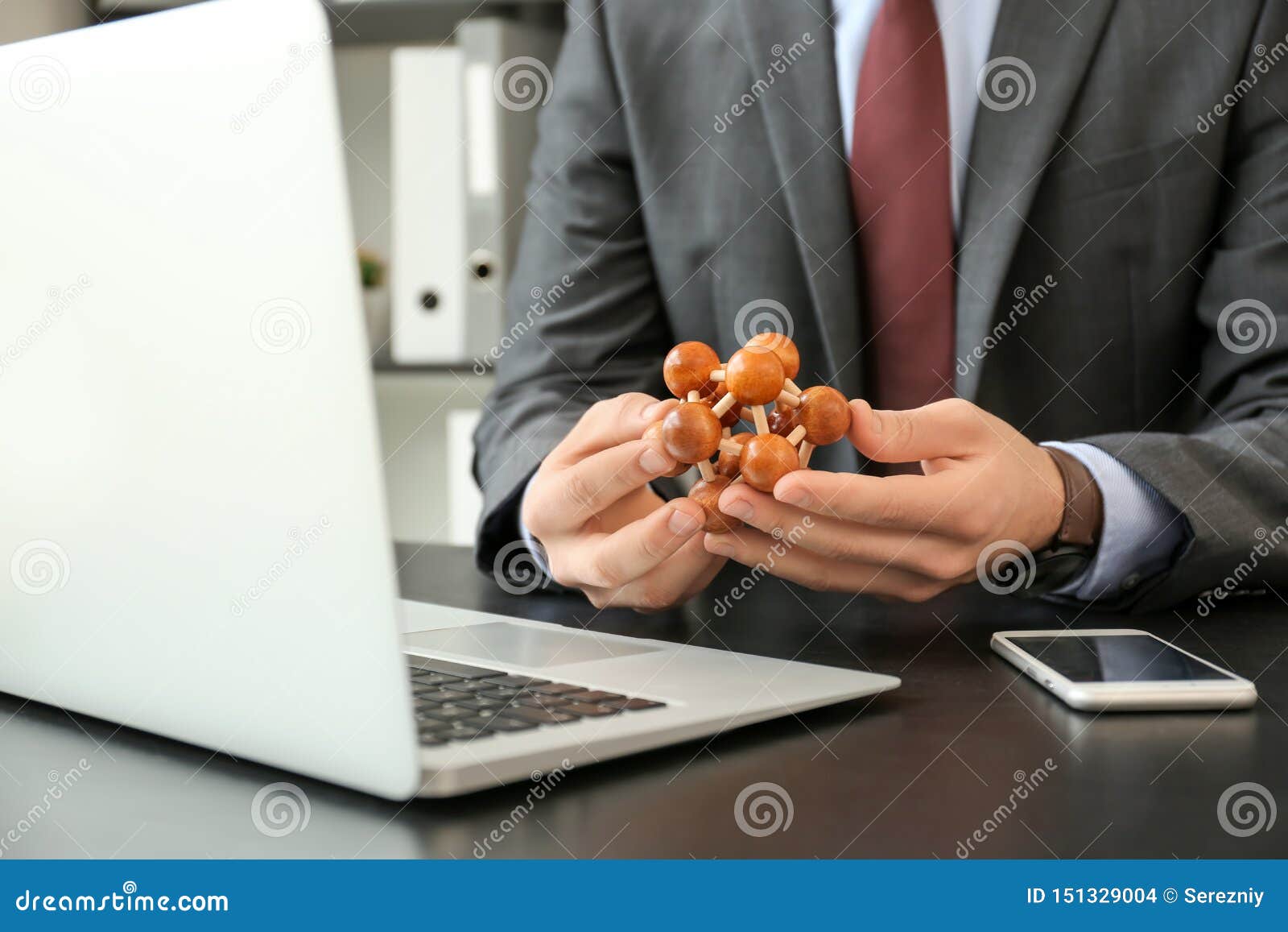 Young Businessman with Brain Teaser at Table in Office Stock Photo ...