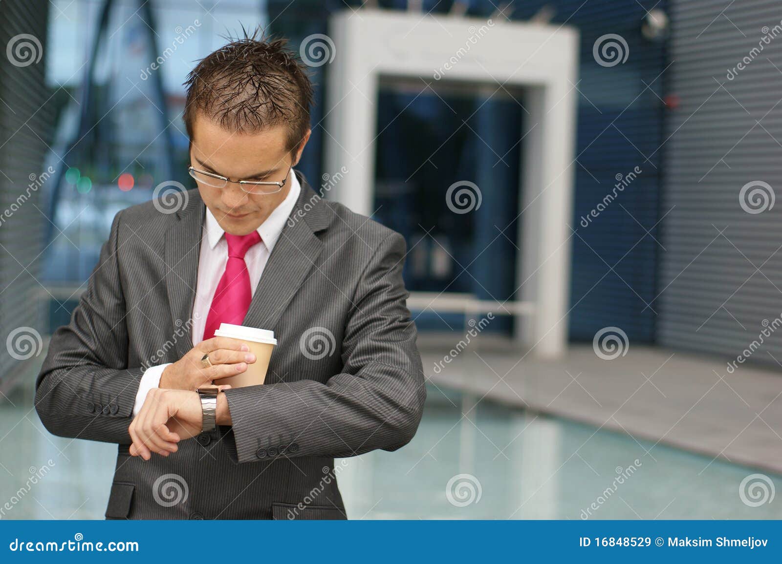 A Young Businessman is Checking the Time Stock Image - Image of alone ...