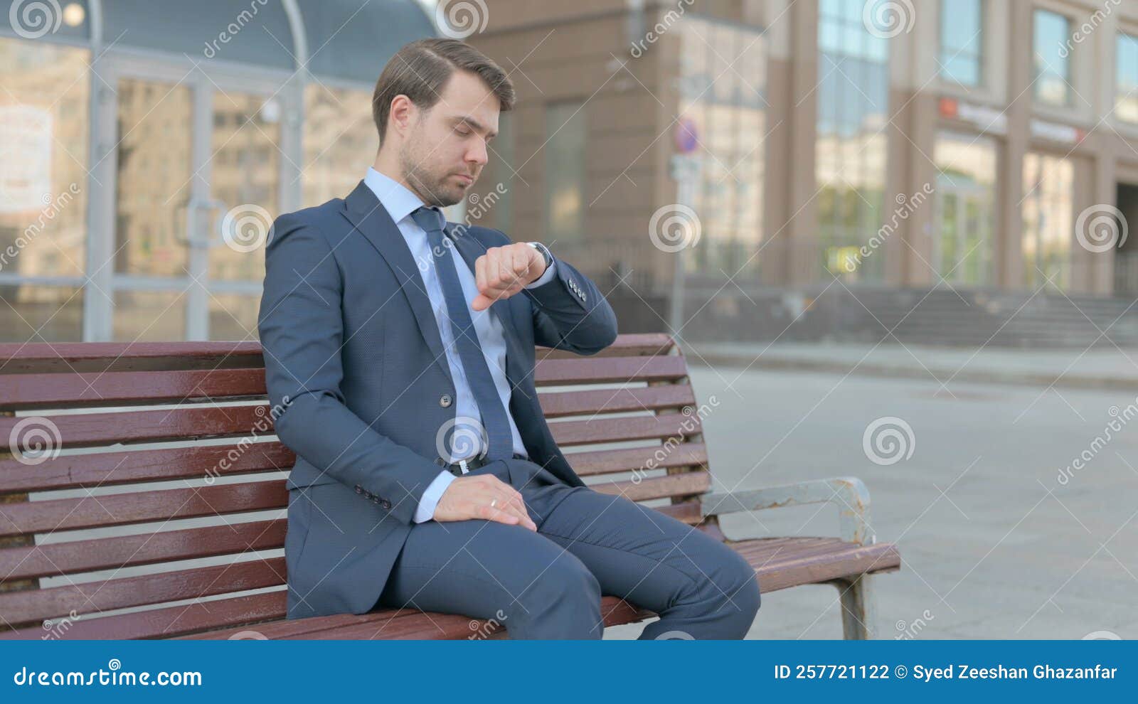 Businessman Checking Time while Waiting on Bench Outdoor Stock Photo ...