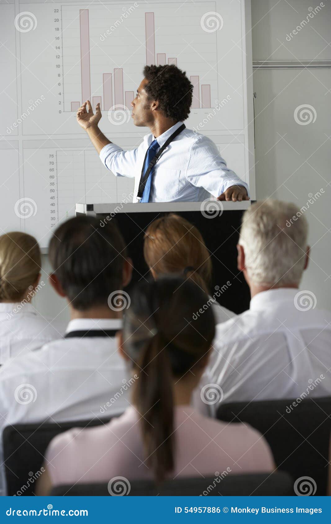 Young Businessman Delivering Presentation at Conference Stock Photo ...