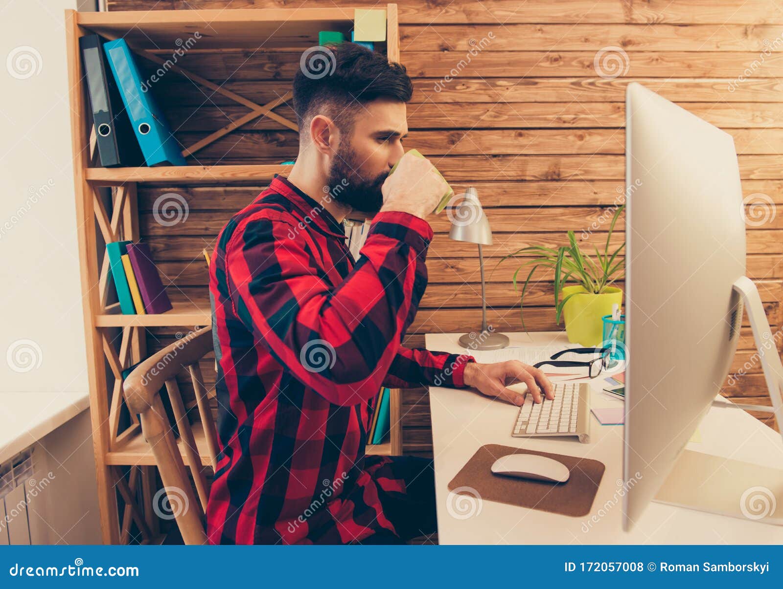 Young Businessman Drinking Coffee while Working on Pc Stock Photo ...