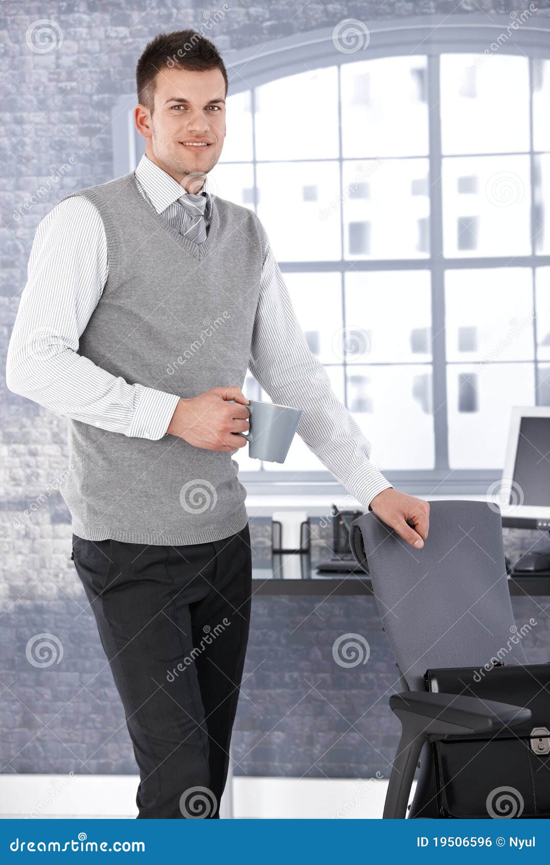 Young Businessman Drinking Tea in Office Smiling Stock Photo - Image of ...