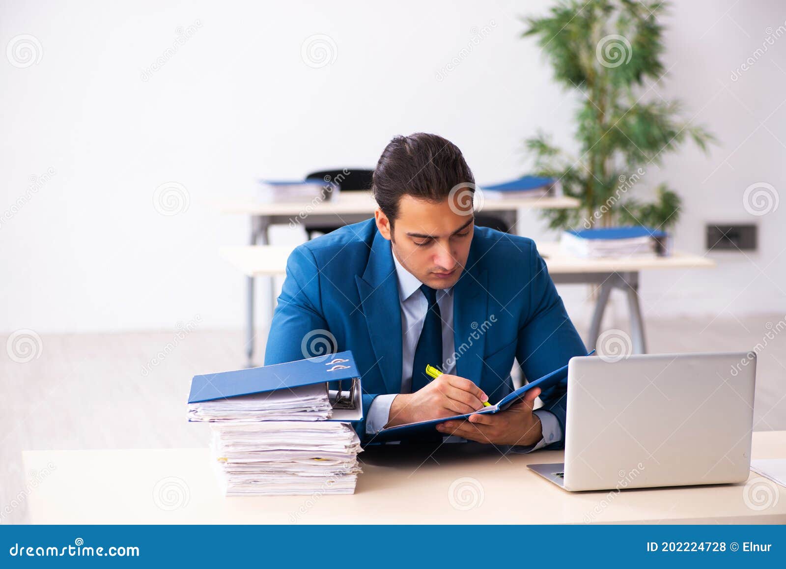 Young Businessman Employee Taking Notes in the Office Stock Photo ...