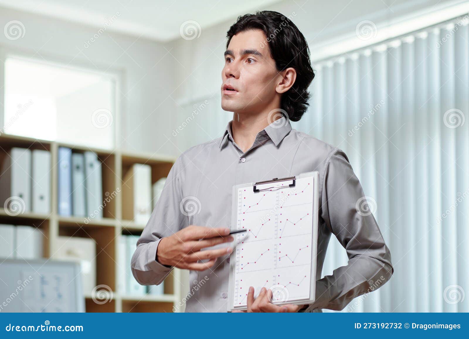 Young Businessman Explaining Graphic Data in Financial Document Stock ...