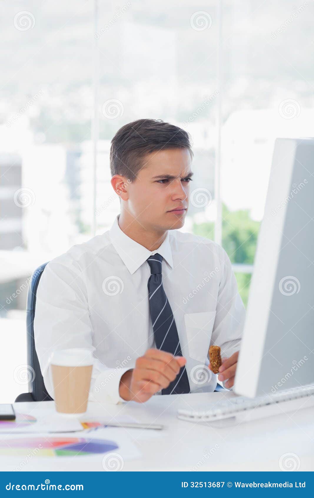 Young Businessman Frowning while Looking at Computer Stock Image ...