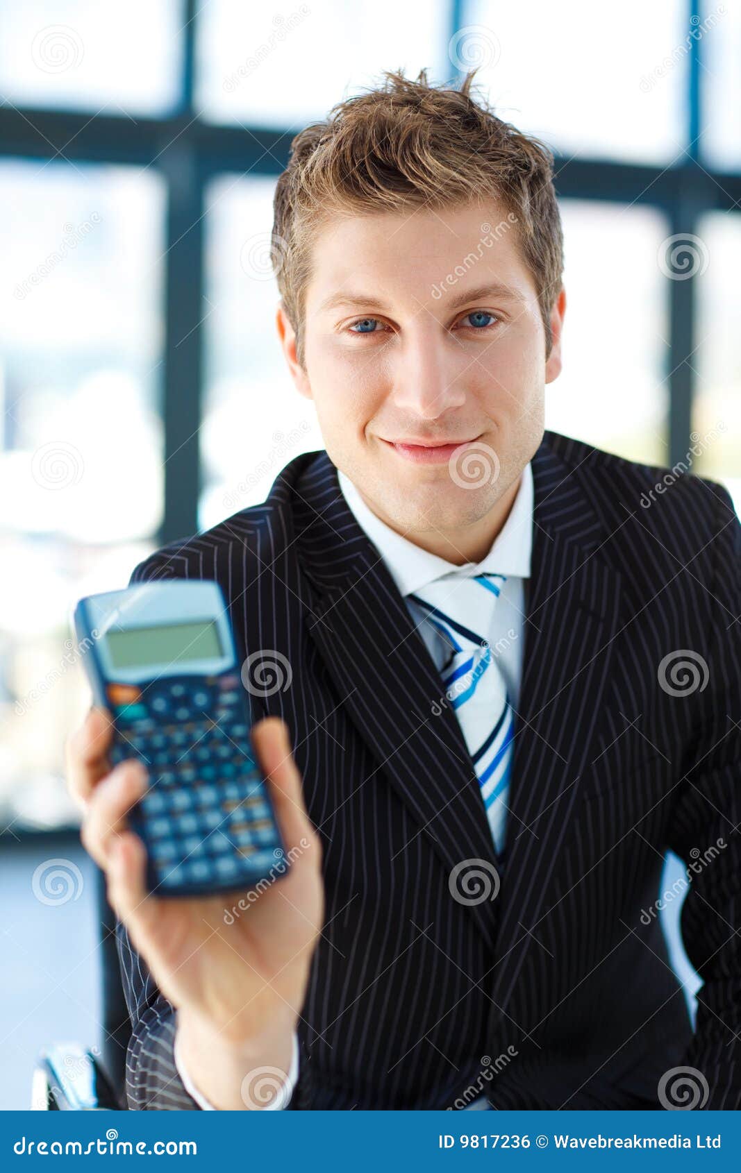 Young Businessman Holding a Calculator Stock Photo - Image of holding ...