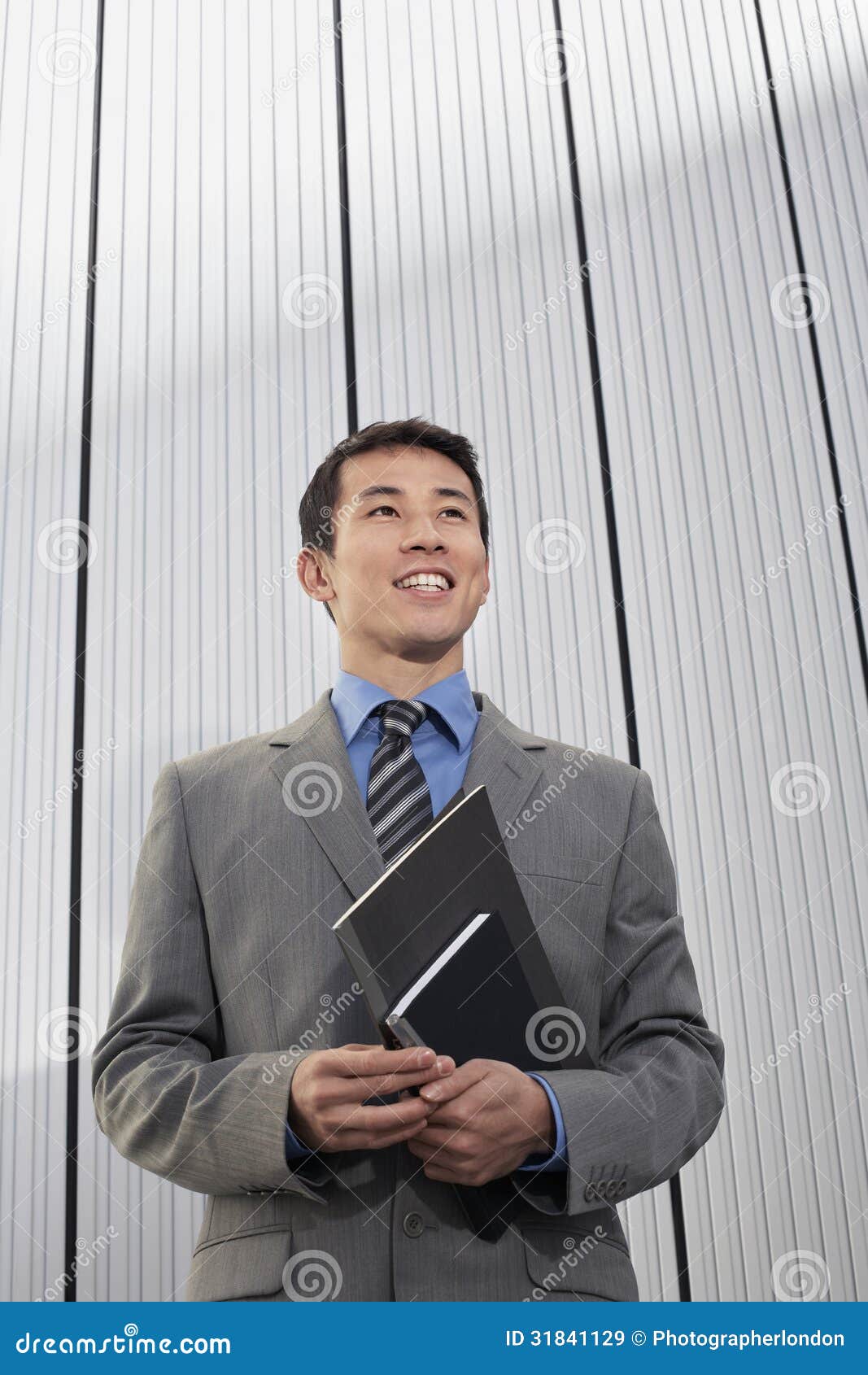 Young Businessman Holding Notebook Stock Image - Image of male, office ...