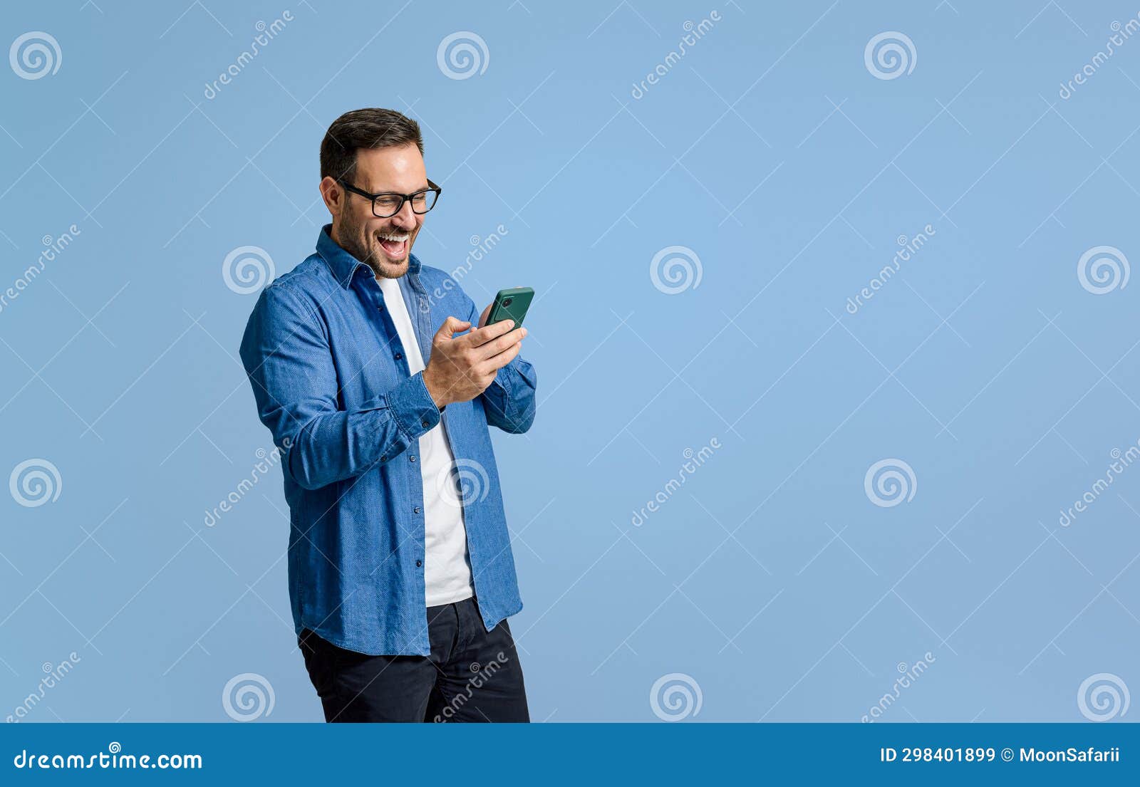 Young Businessman Laughing Ecstatically while Reading Messages Over ...