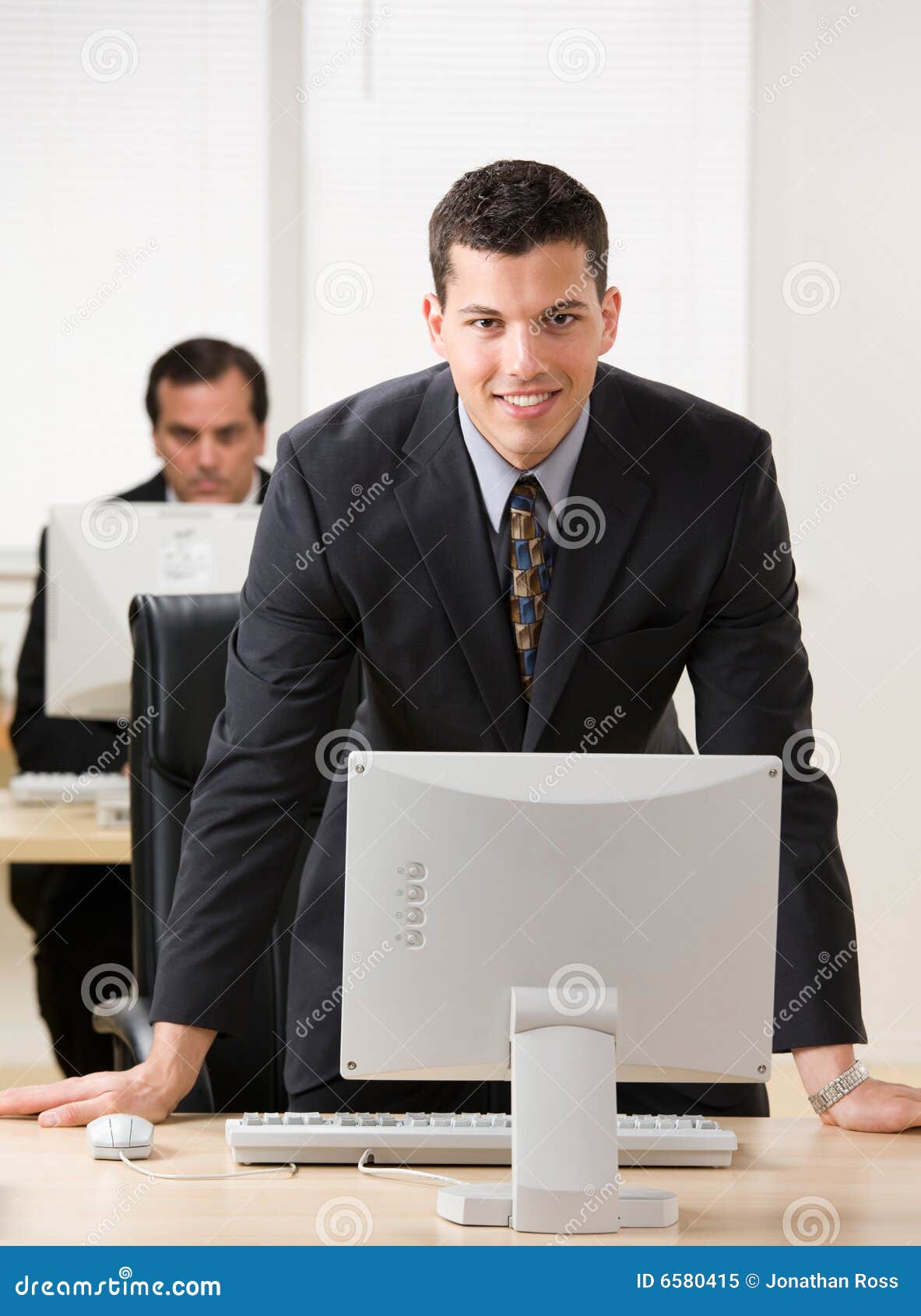 Young Businessman Leaning on Desk Stock Image - Image of monitor ...
