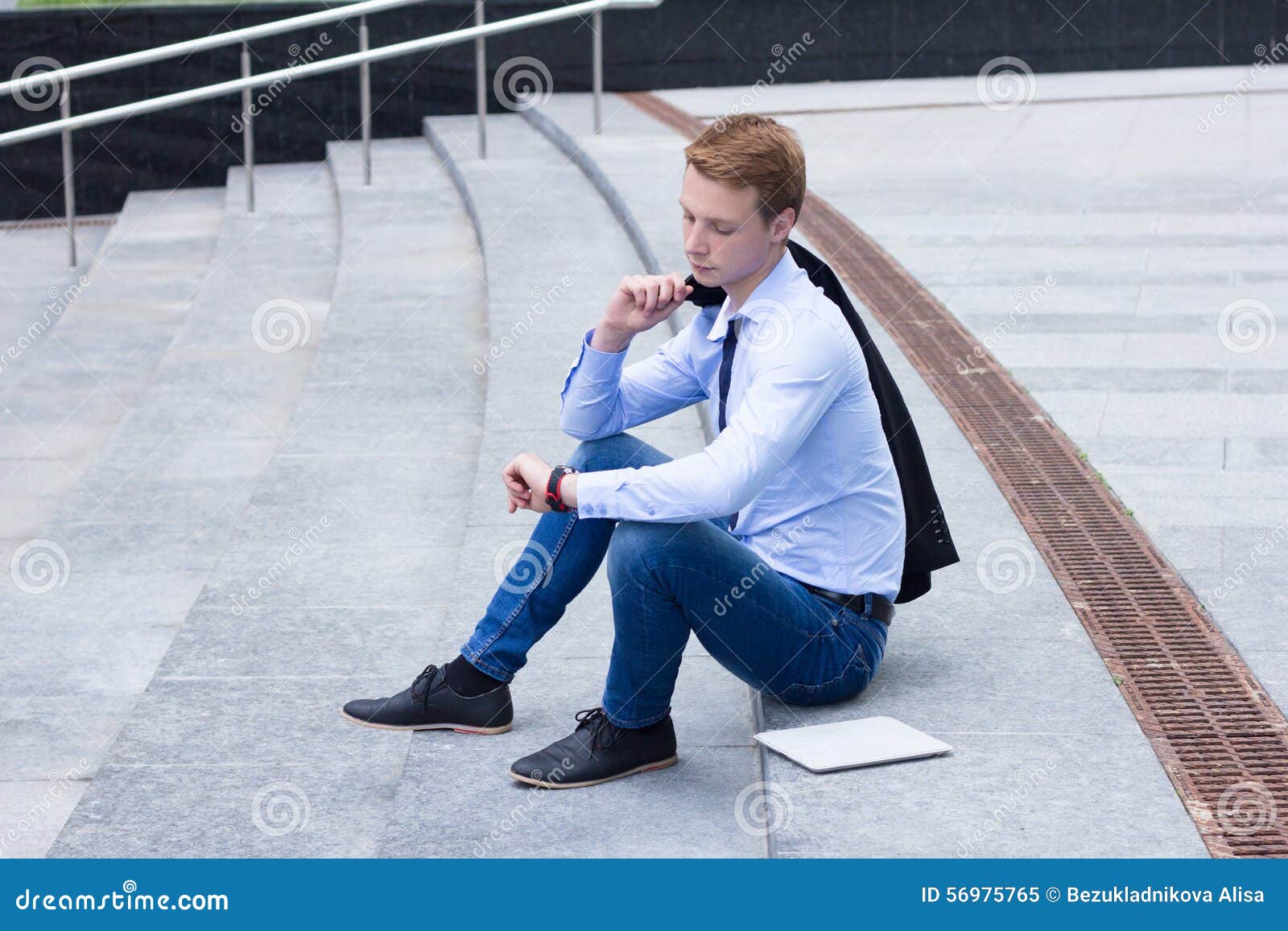 Young Businessman Looking at the Clock and Waiting for the Client Stock ...