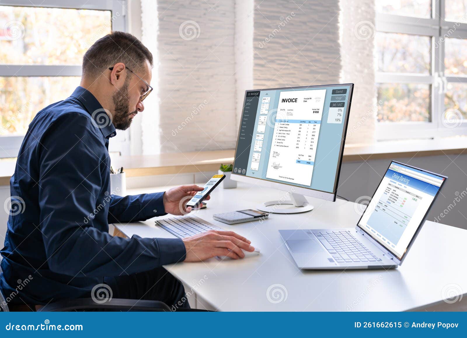 Young Businessman Looking at Invoice while Doing Online Banking Stock ...