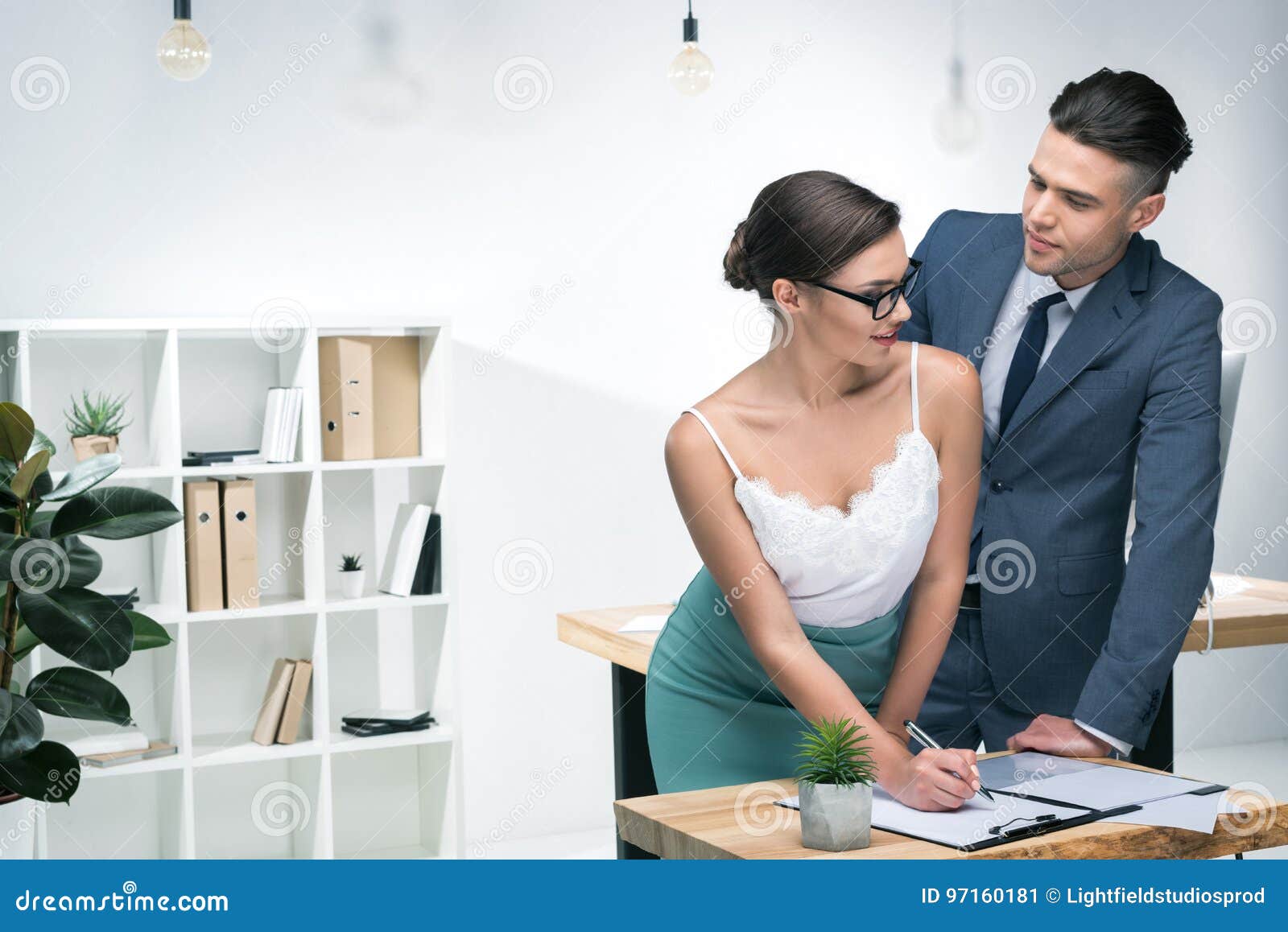 Young Businessman Looking At Seductive Businesswoman Working In Office Stock Image Image Of 3717