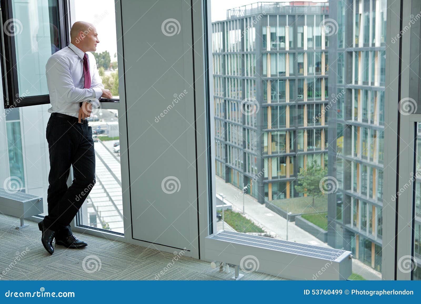 Young Businessman Looking Thru Window Stock Photos - Free & Royalty ...