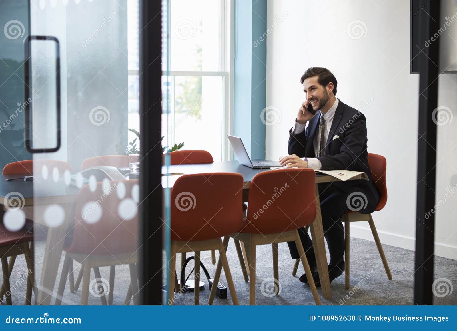 Young Businessman Making a Phone Call in a Boardroom Stock Photo ...