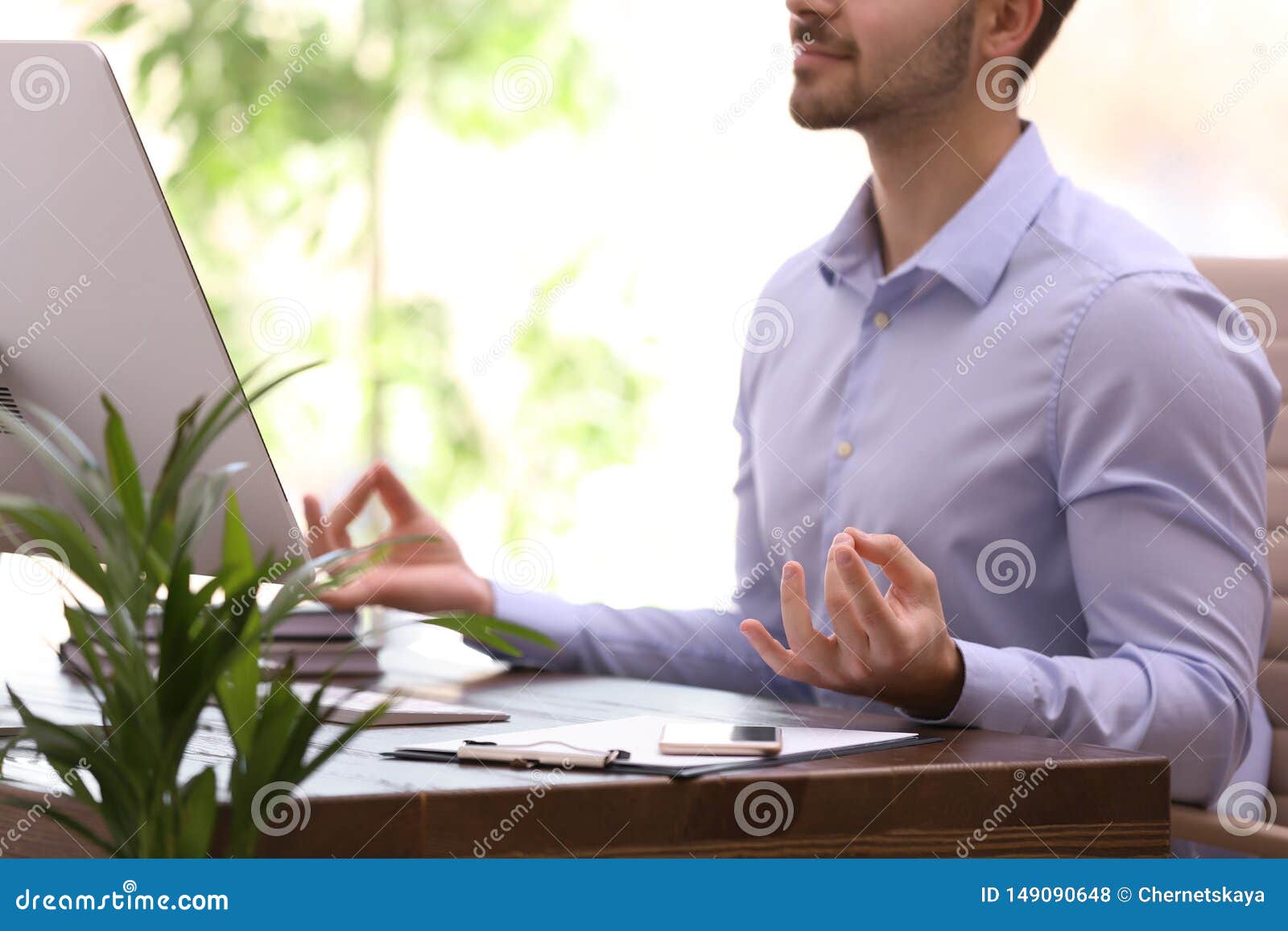 Young Businessman Meditating at Workplace. Zen Concept Stock Photo ...