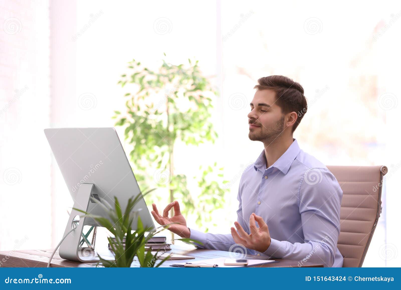 Young Businessman Meditating at Workplace Stock Photo - Image of ...