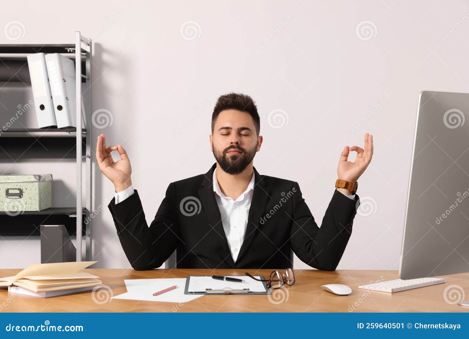 Young Businessman Meditating at Workplace. Zen Concept Stock Image ...