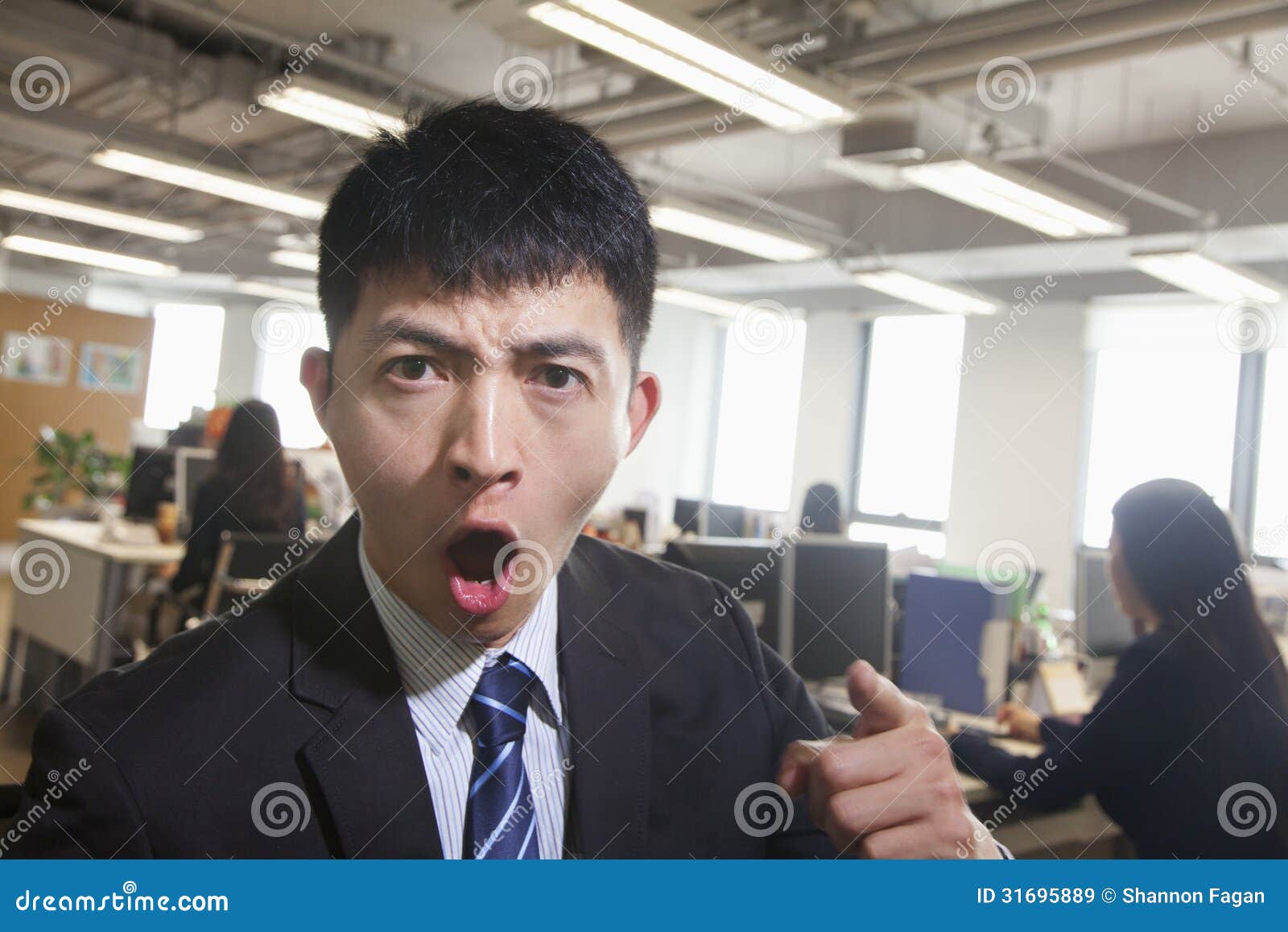 Young Businessman Pointing and Shouting, Looking at Camera Stock Image ...
