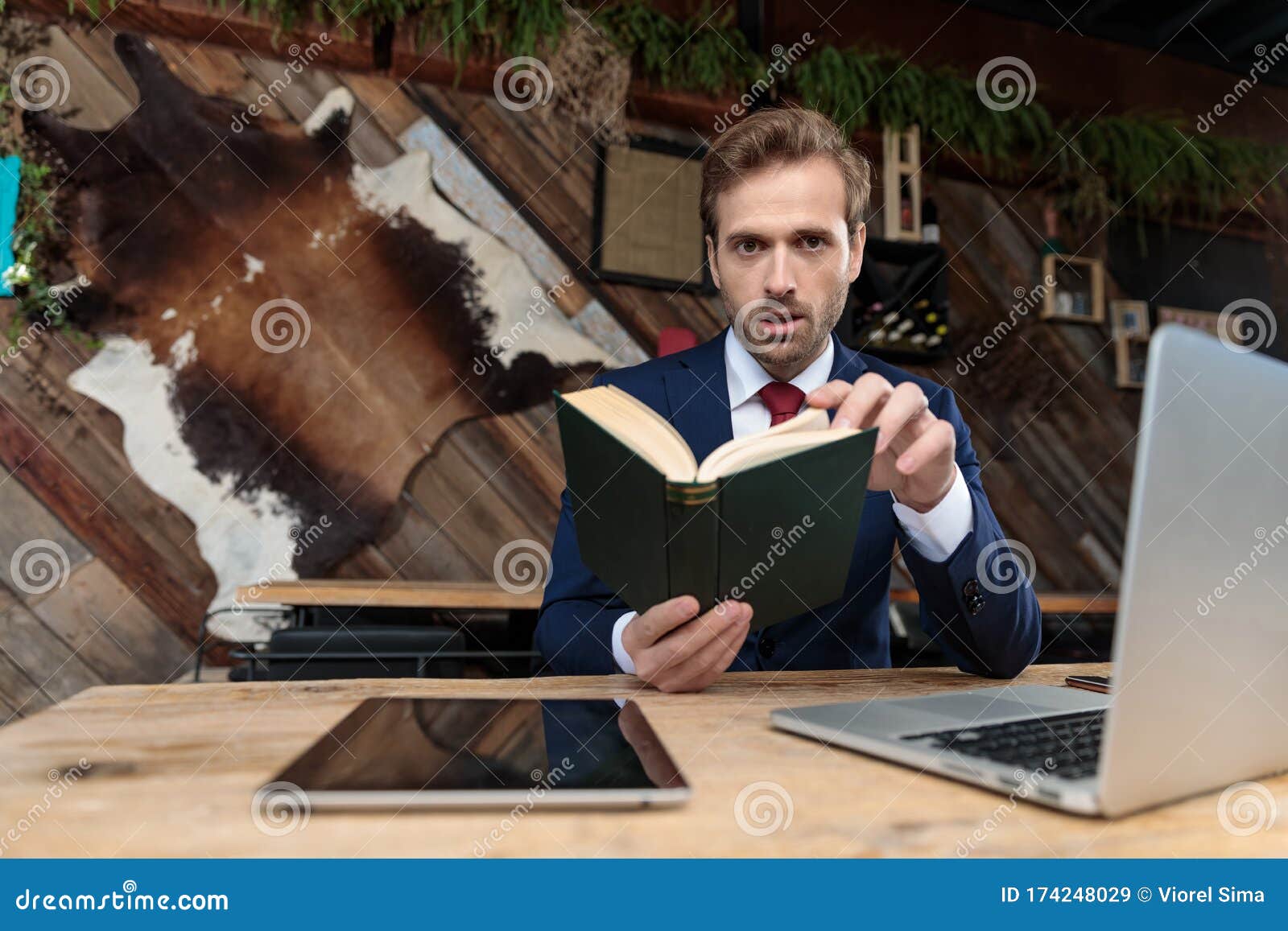 Young Businessman Reading a Book in a Coffeeshop Stock Image - Image of ...