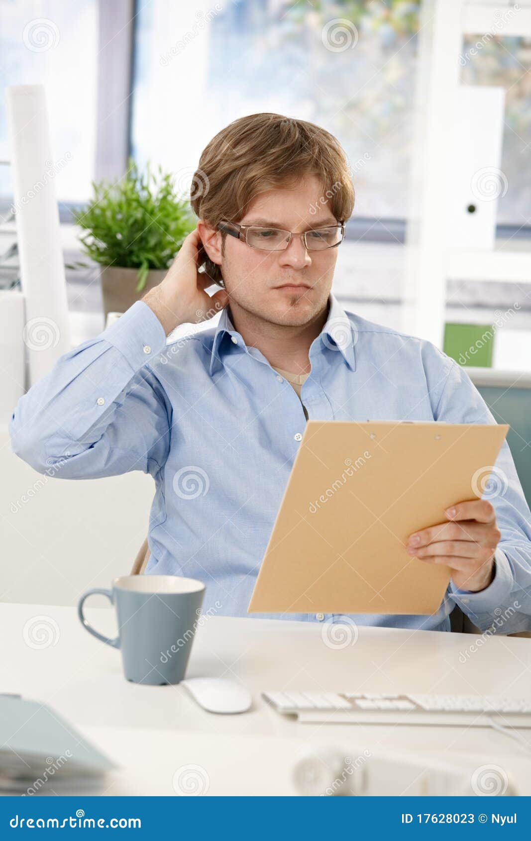 Young Businessman Reading Document Stock Image - Image of look, alone ...