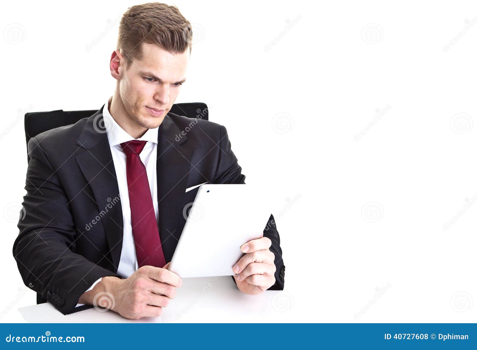 Young Businessman Reading on His Modern Tablet Computer / Touchpad ...