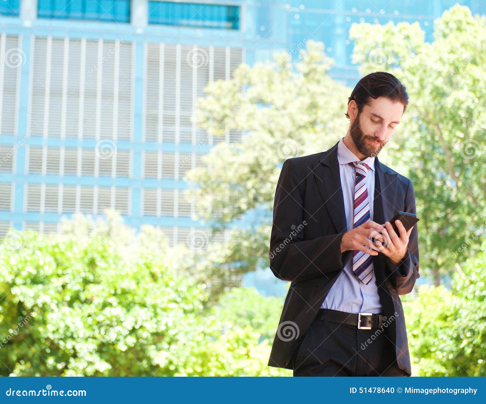 Young Businessman Reading Text Message on Mobile Phone Stock Photo ...