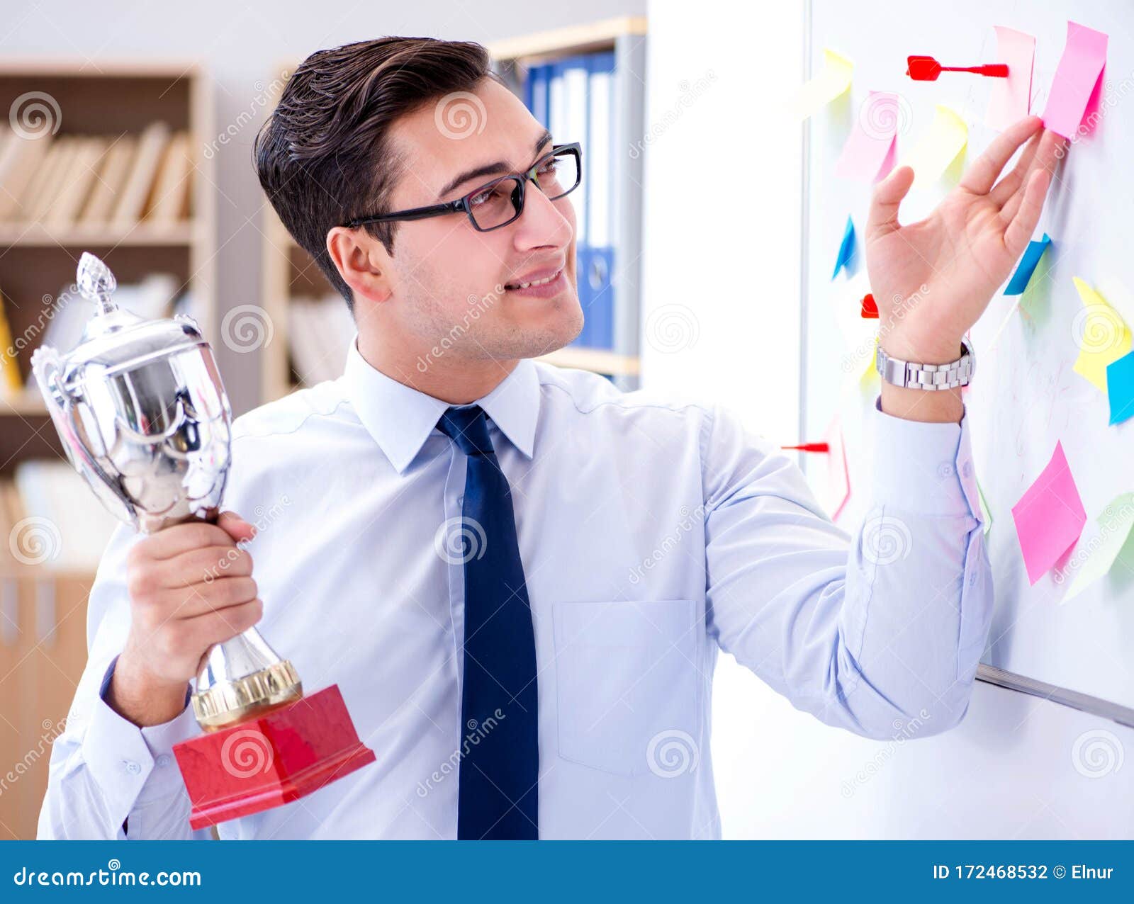 Young Businessman Receiving Prize Cup in Office Stock Photo - Image of ...