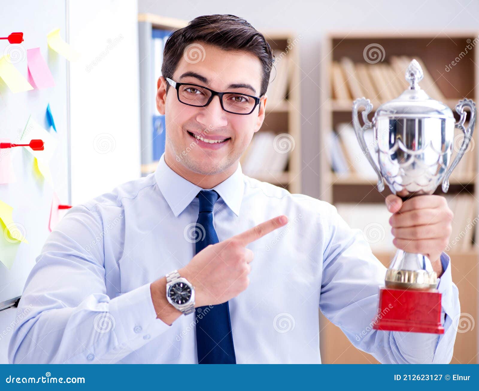 Young Businessman Receiving Prize Cup in Office Stock Image - Image of ...