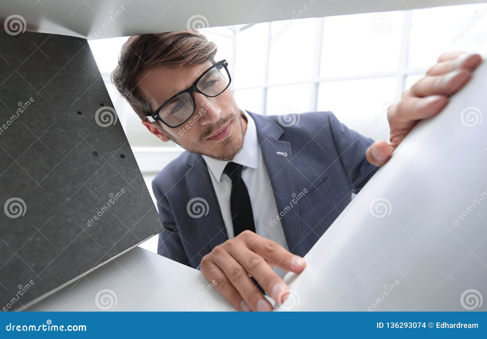 Young Businessman Selects a Folder for Documents Stock Photo - Image of ...