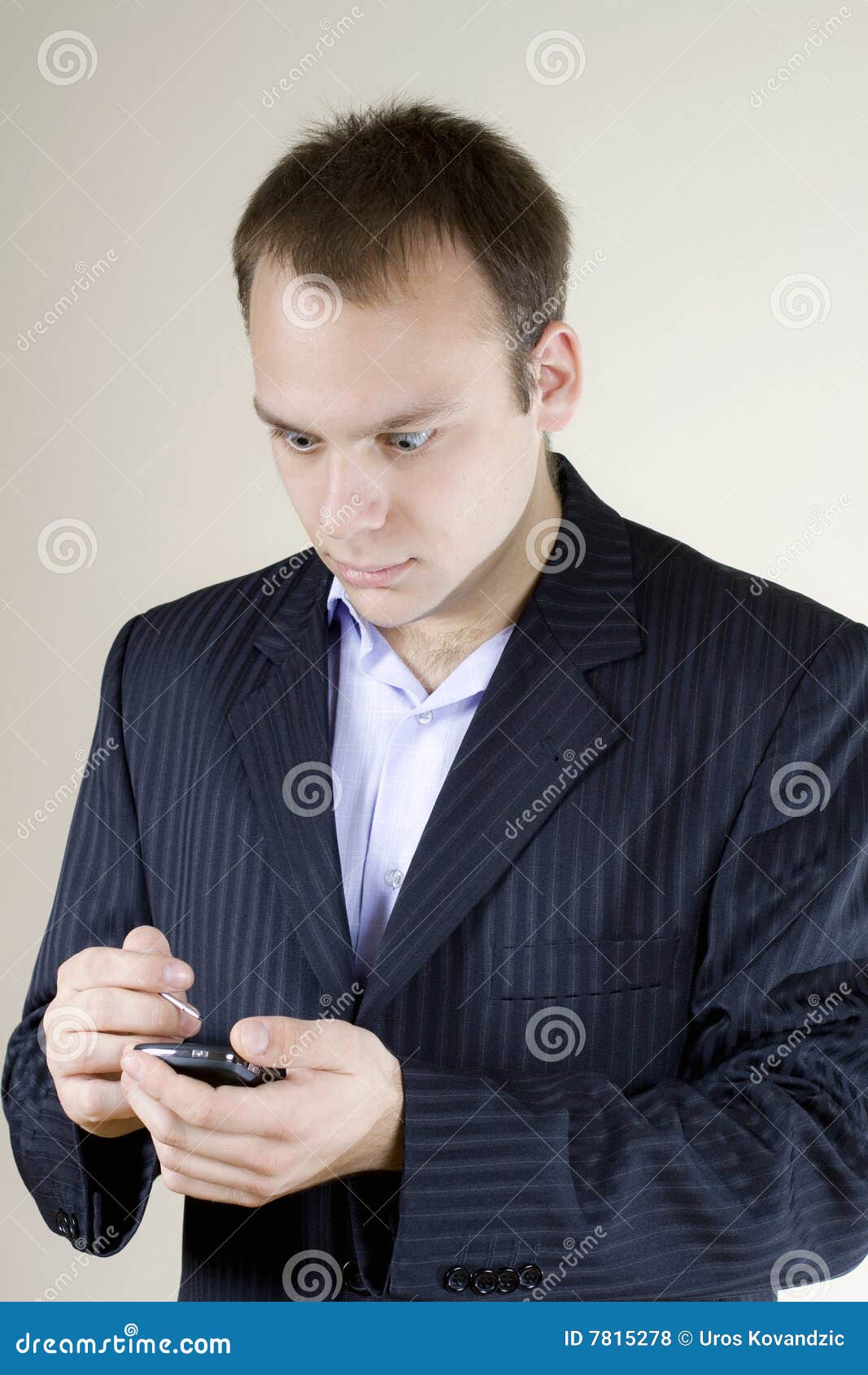 Young Businessman Shocked with Cellphone Stock Photo - Image of ...